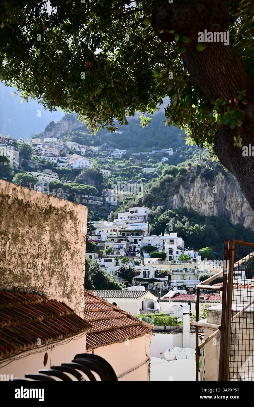 A serene view of a hillside Italian village, where colorful ...