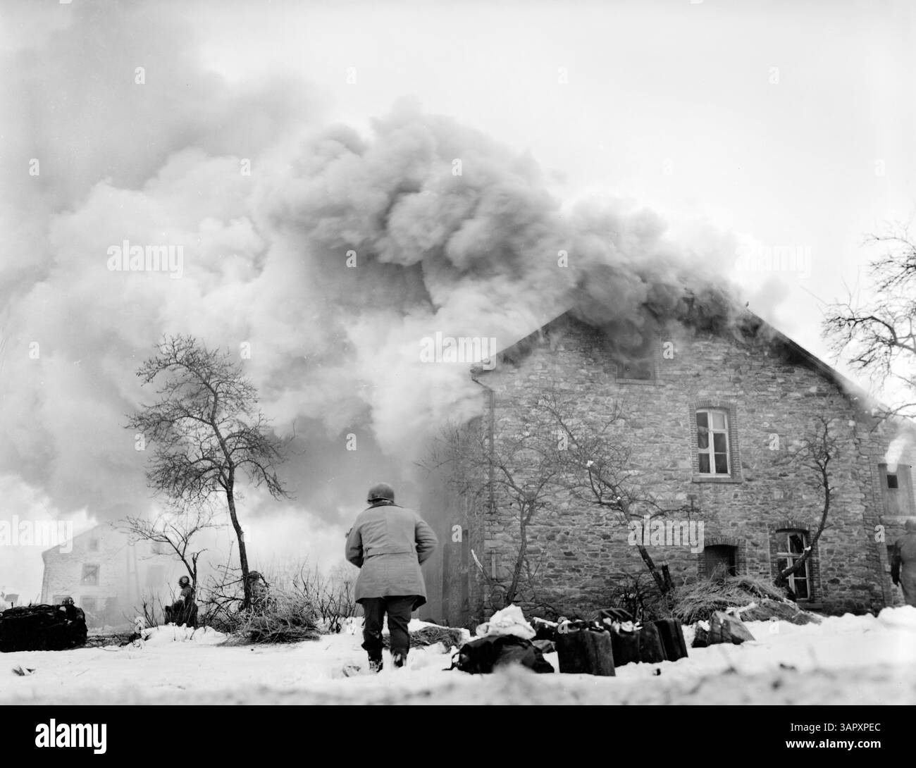 Burning home drew heavy barrage of enemy shellfire, near Lmore, Belgium ...