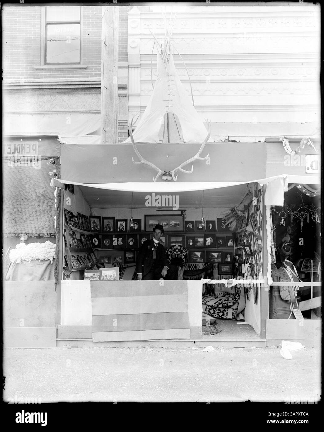 Photograph of a man standing in a temporary structure, captured in ...