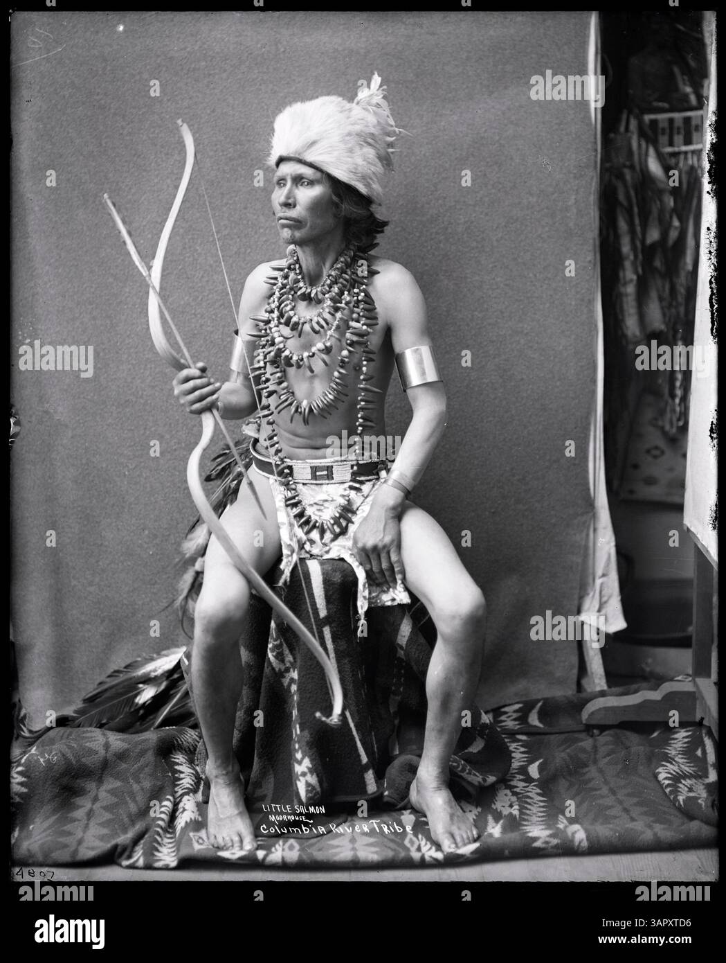 Little Salmon, a Columbia River Indian, is shown in traditional regalia ...