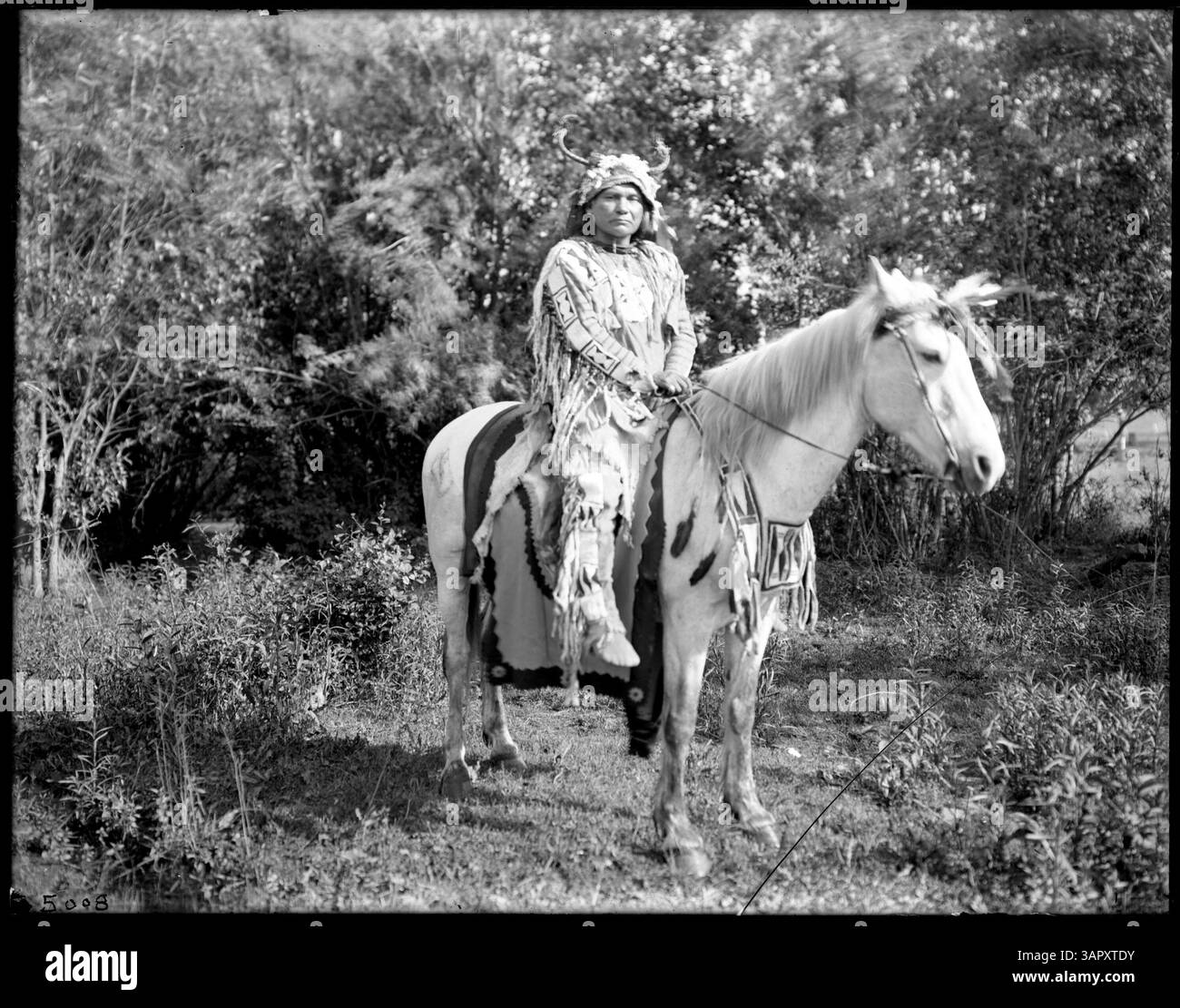 Luke Minthorn is depicted in traditional regalia on horseback, wearing ...