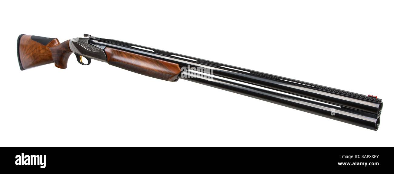 Elegant over-under shotgun with engraved receiver and wooden stock ...