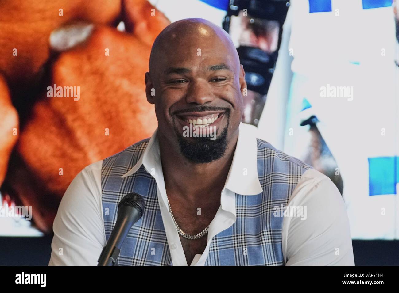 Football player Tyron Smith speaks during a press conference where he ...