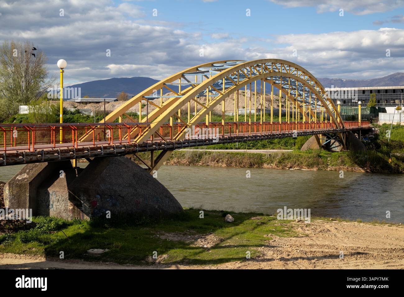 Yellow Arched Bridge Over River Landscape Stock Photo - Alamy