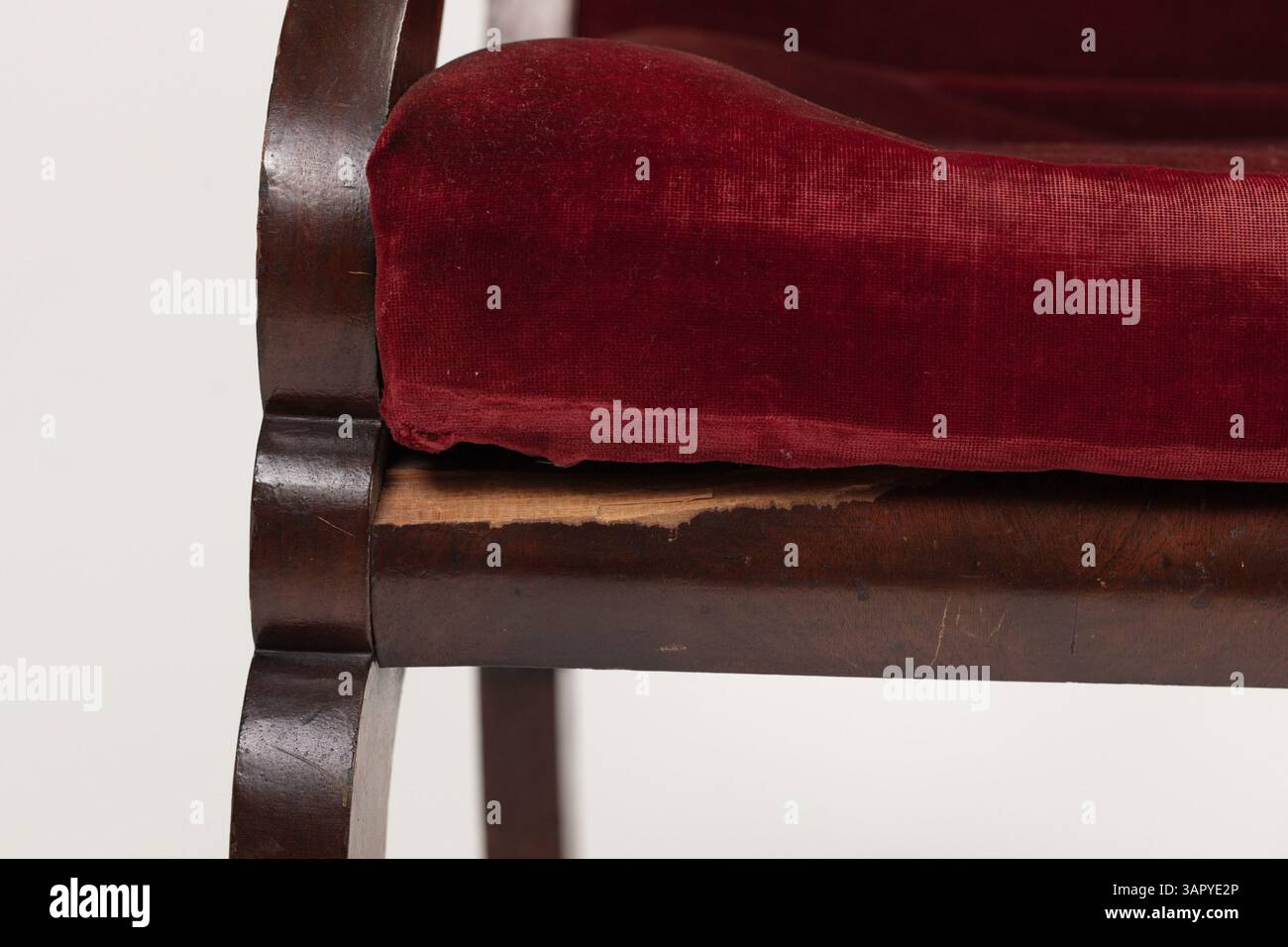 This high-backed priest's chair, featuring a red velvet seat and back ...