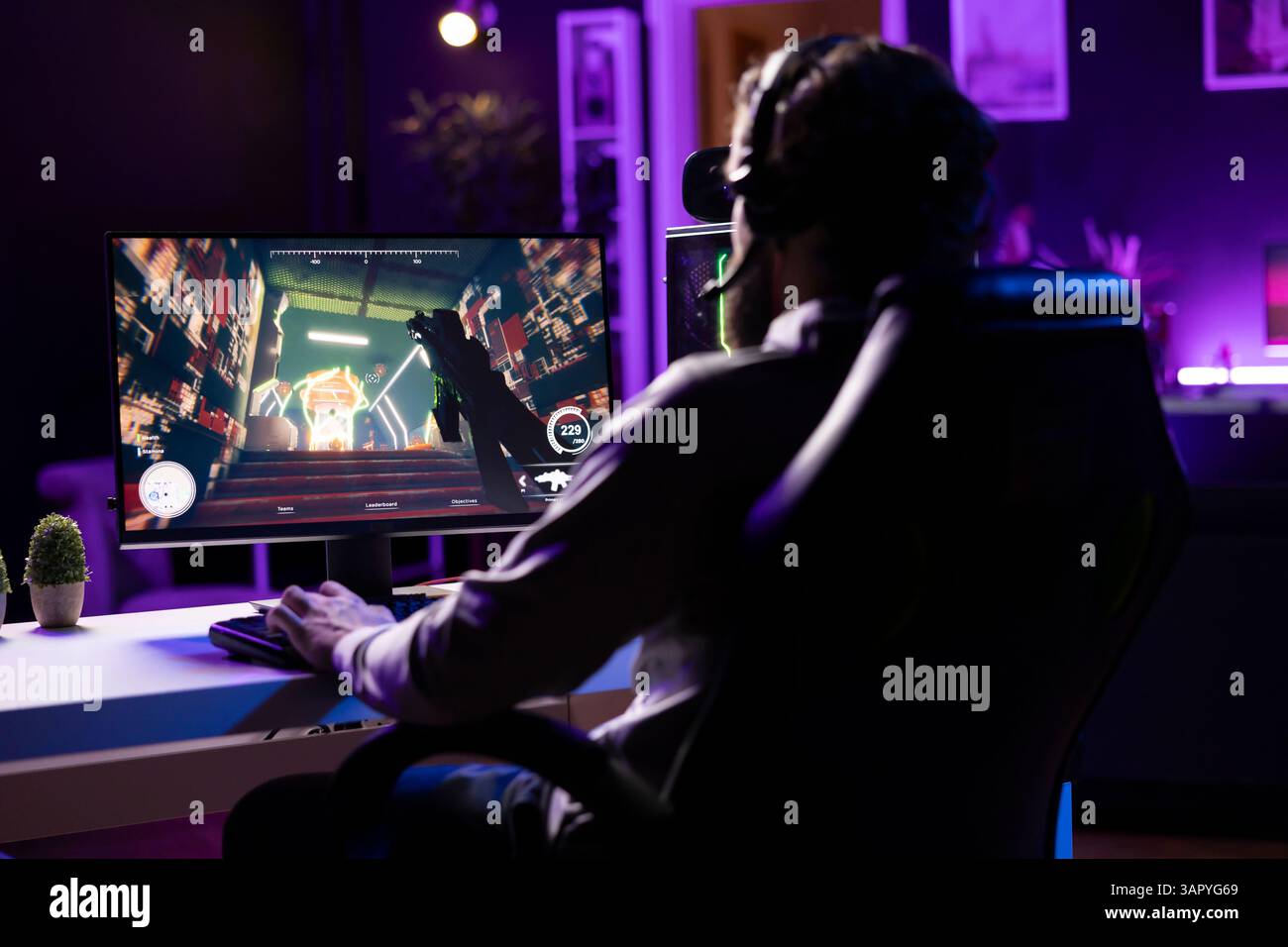 Player wearing headphones reaching final mission in FPS videogame ...