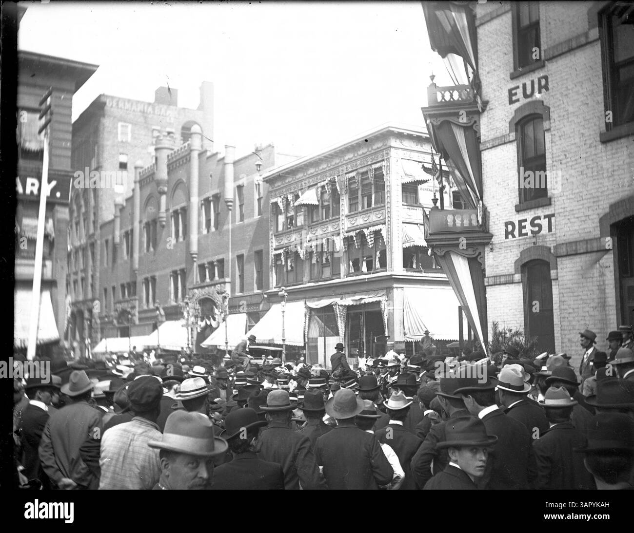 A crowd gathers outside the Windsor Hotel for a political speech, with ...