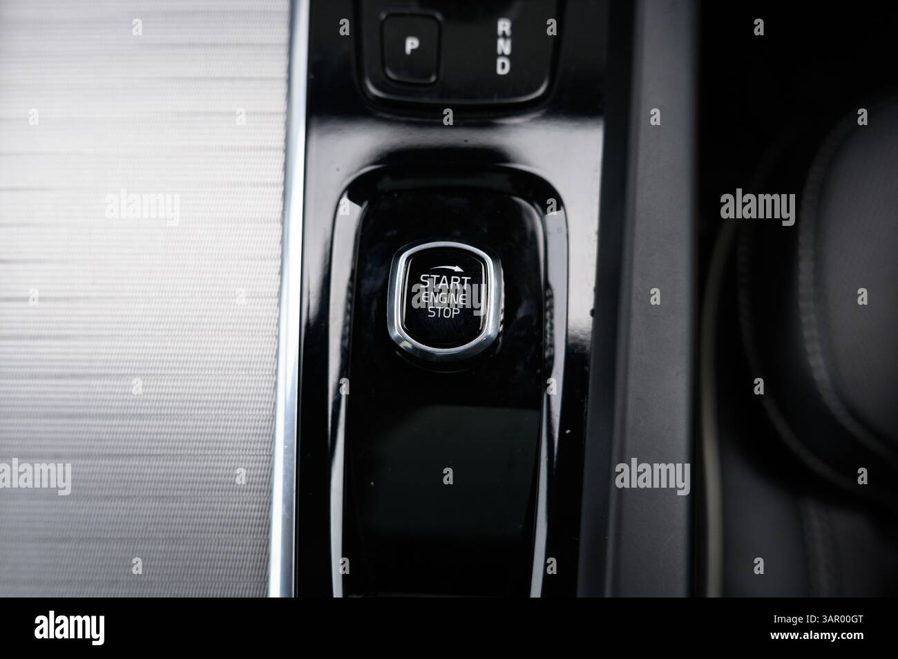 A car's dashboard has a start button and a stop button. The buttons are ...