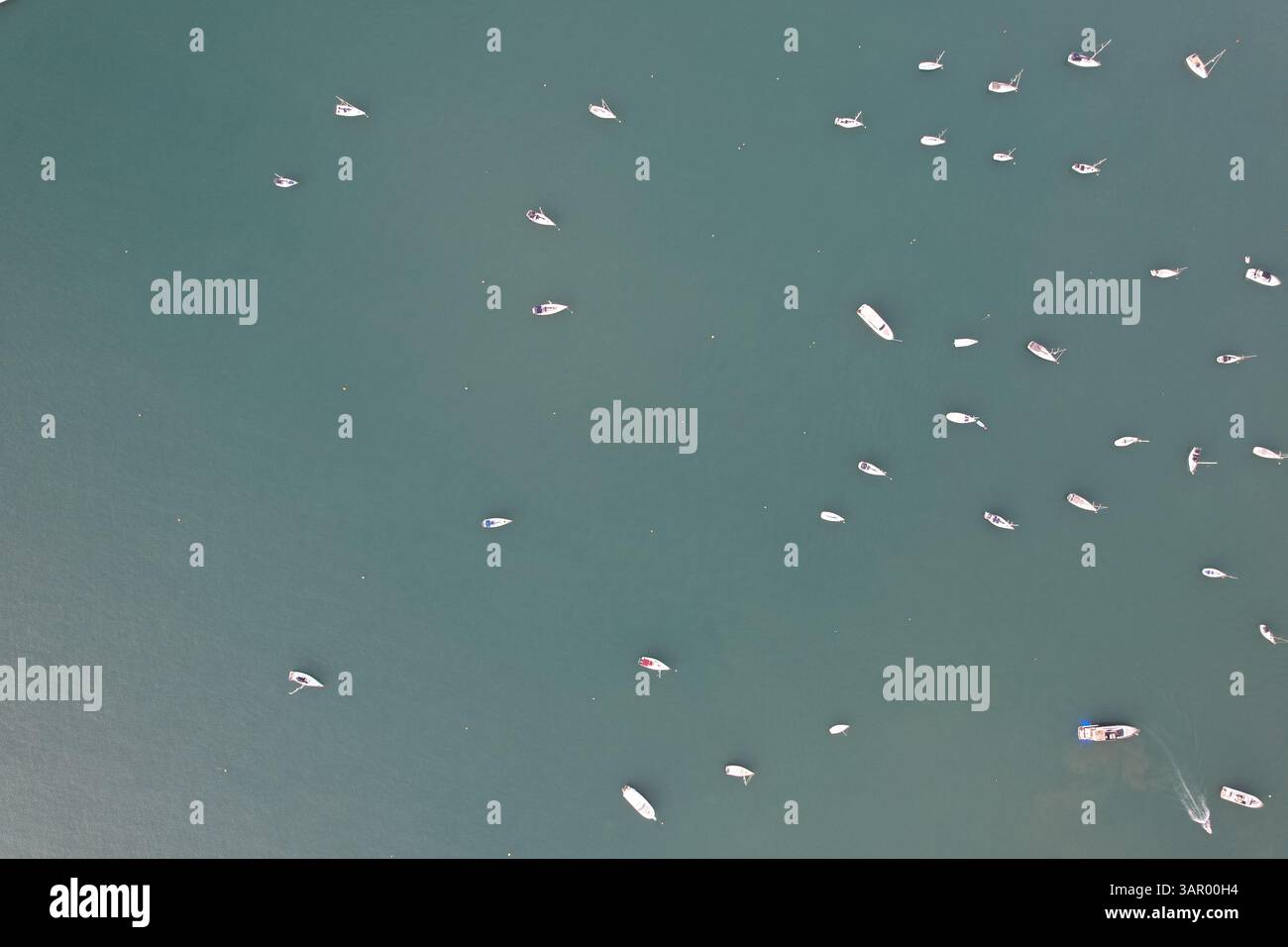 Boats floating on calm water in a scenic coastal area during daytime ...