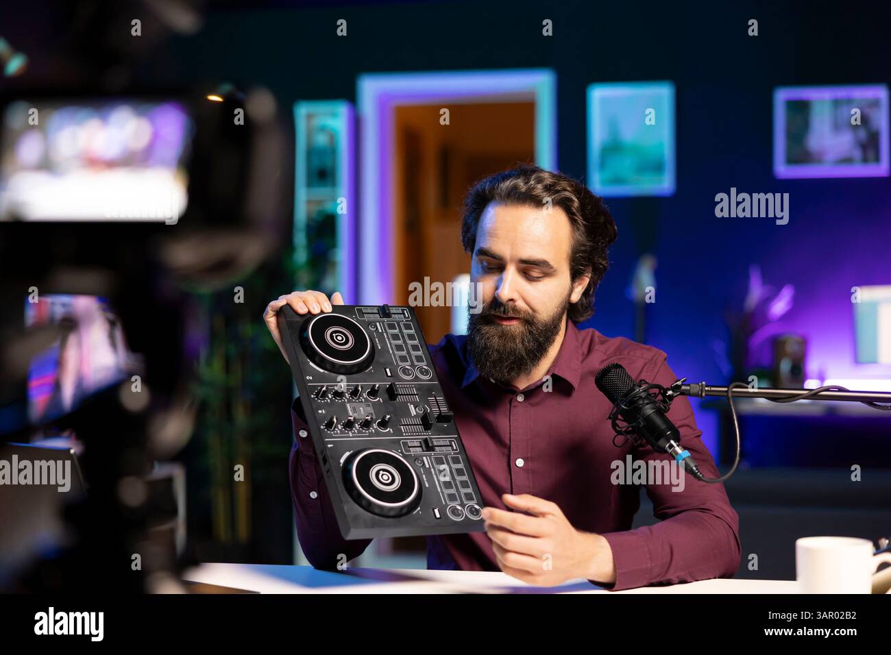 Artist filming DJ mixing tutorial, showing fans examples of sampling on ...