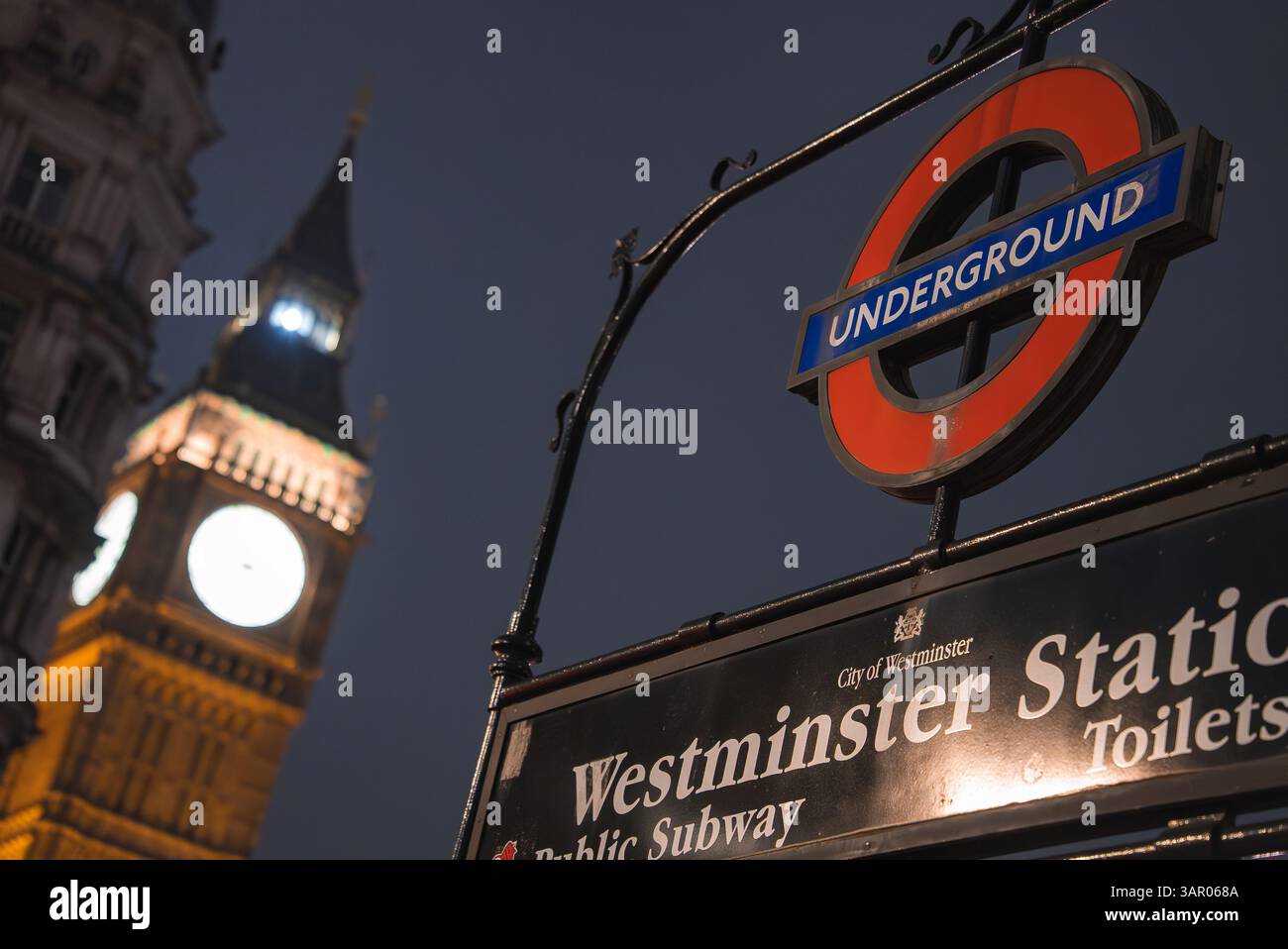 Westminster Station Sign and Big Ben Illuminated at Night Stock Photo ...