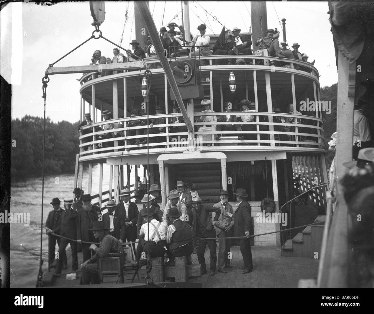 A group of passengers aboard a Mississippi River steamboat at a landing ...