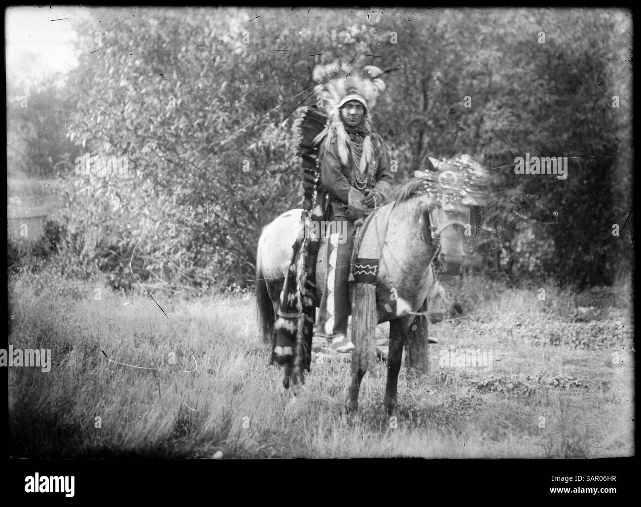 This photograph captures a tribal member on horseback. The image ...