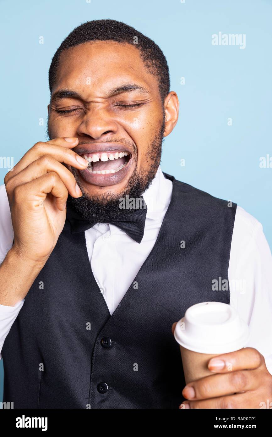 Tired hotel employee yawning hi-res stock photography and images - Alamy