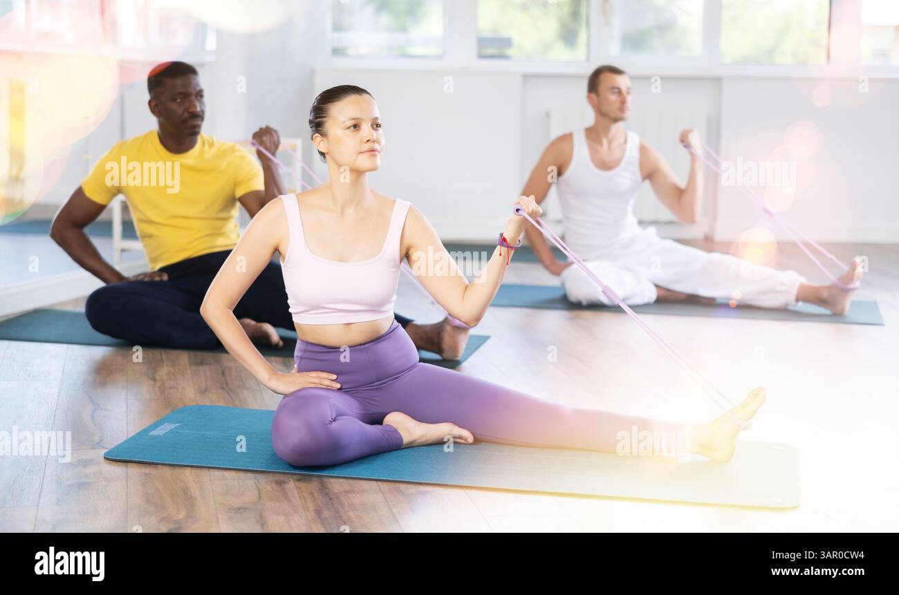 Group of of active people of different nationalities exercising their ...