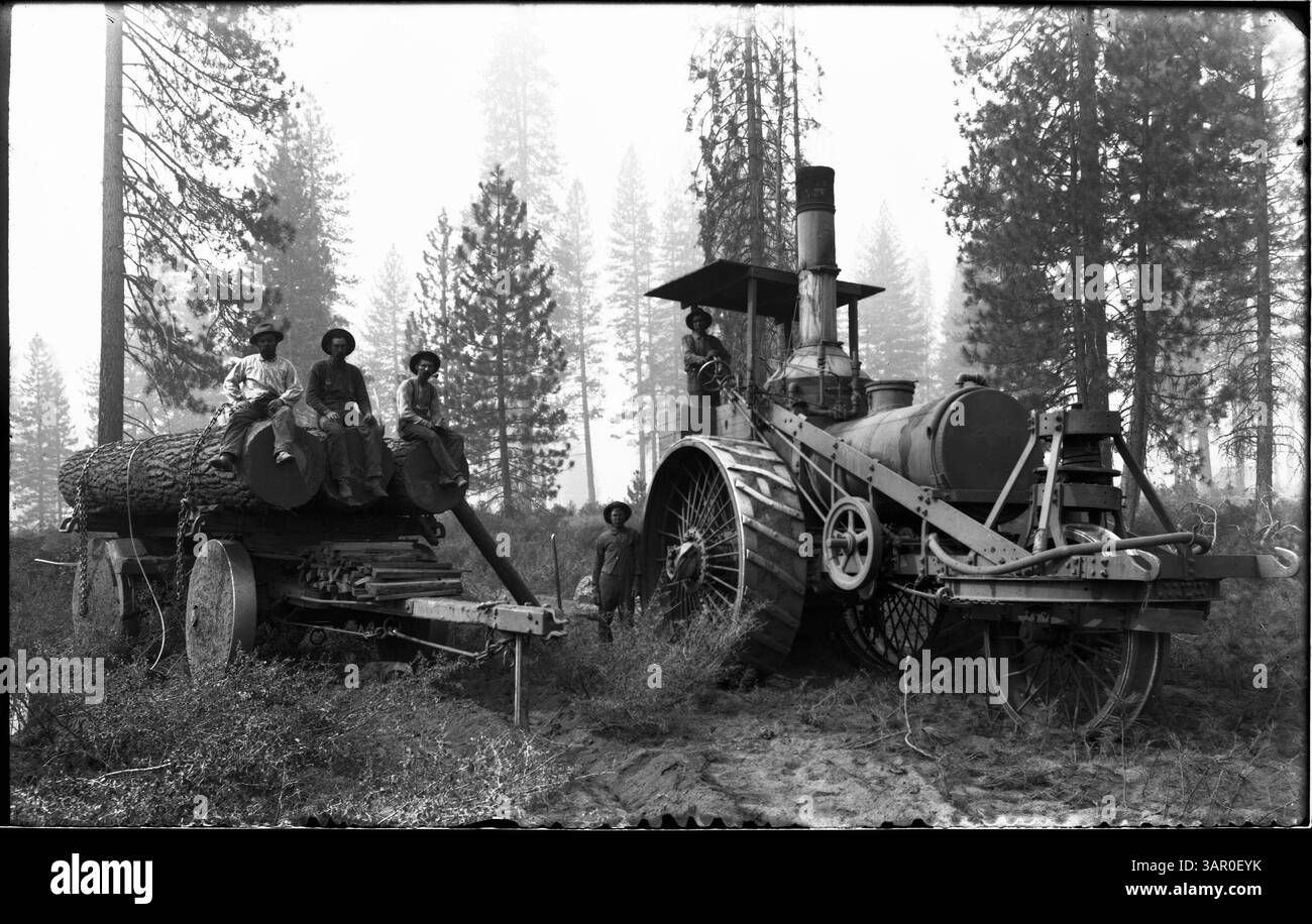 This photograph depicts an old-time tractor with a log cart, captured ...