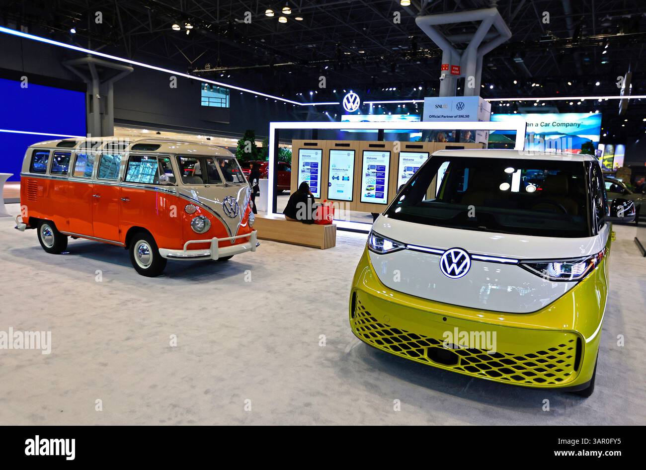 A vintage 1967 Volkswagen bus (L) and the new 2025 Volkswagen Buzz on ...