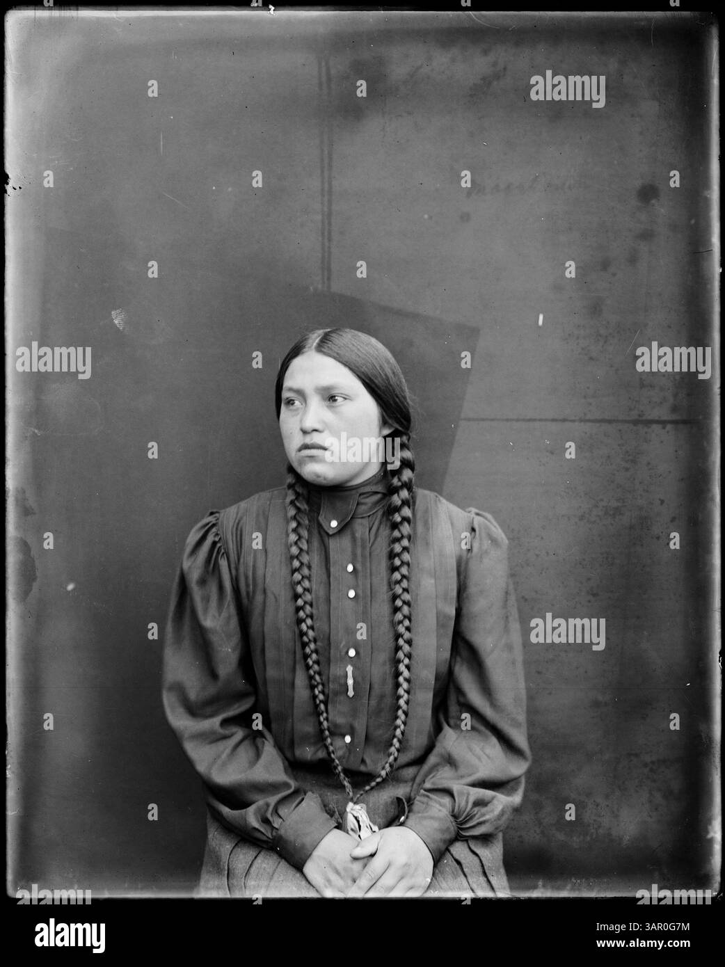 This photograph features a Native American woman dressed in western ...