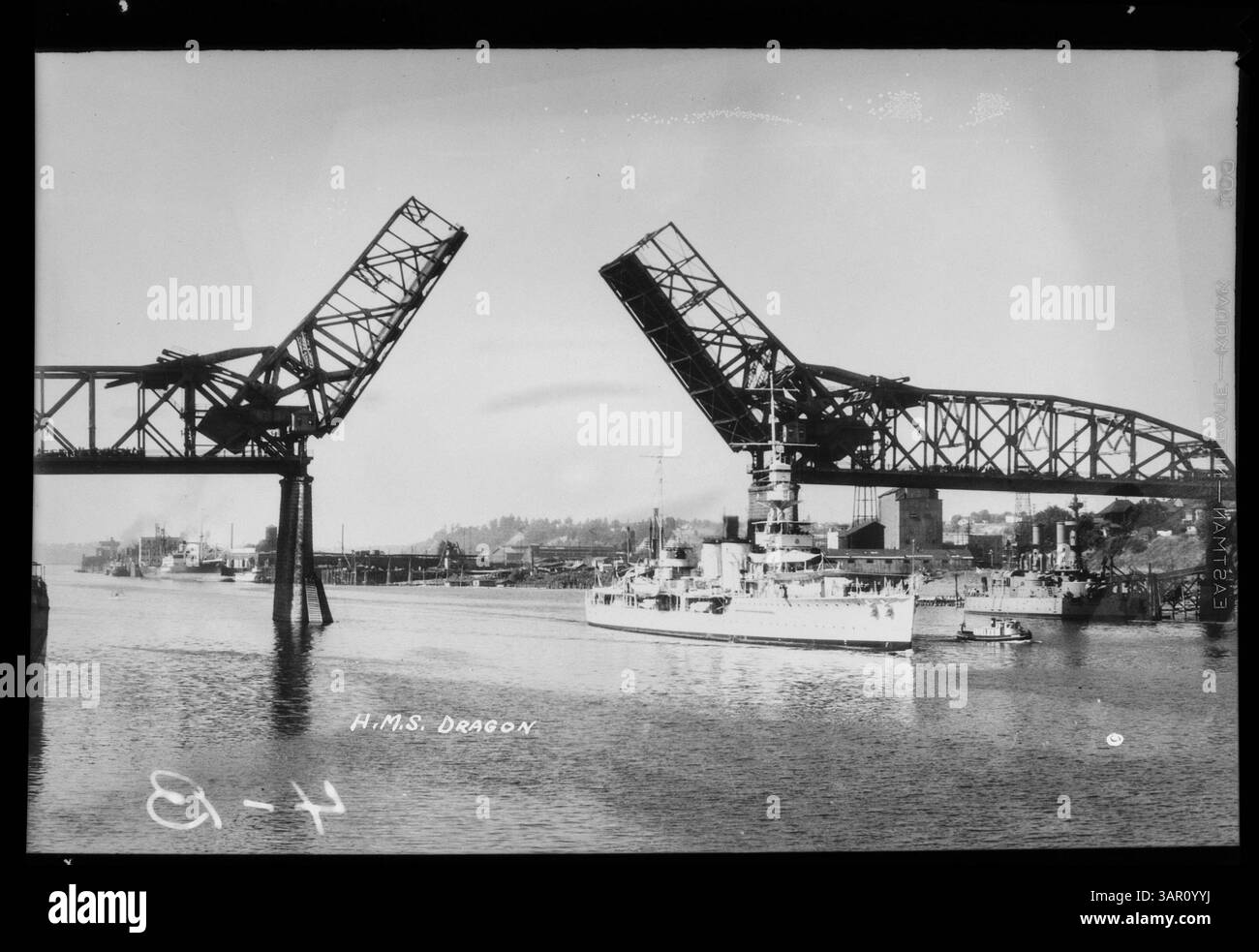 Image shows the HMS Dragon passing under a drawbridge. The photograph ...