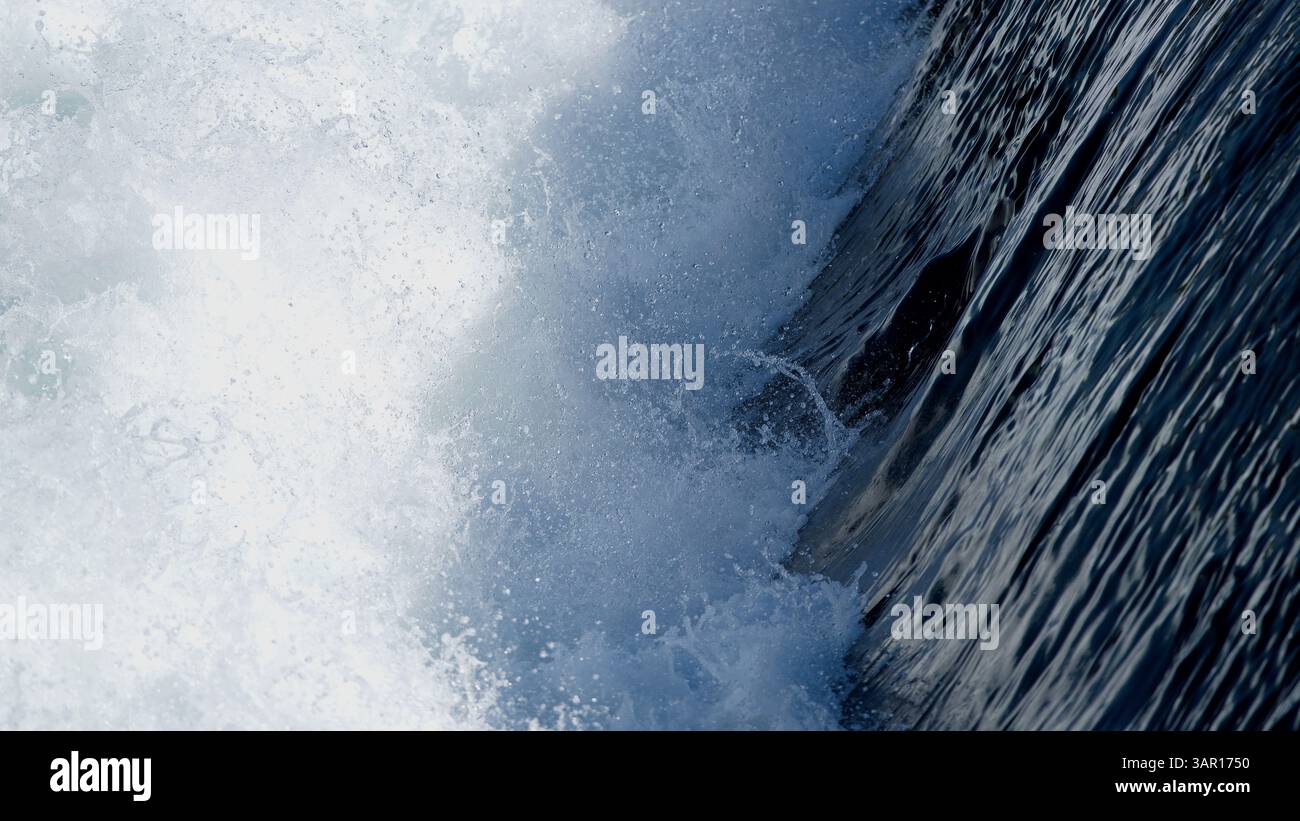 A detailed view of water plunging over Niagara Falls, showcasing the ...