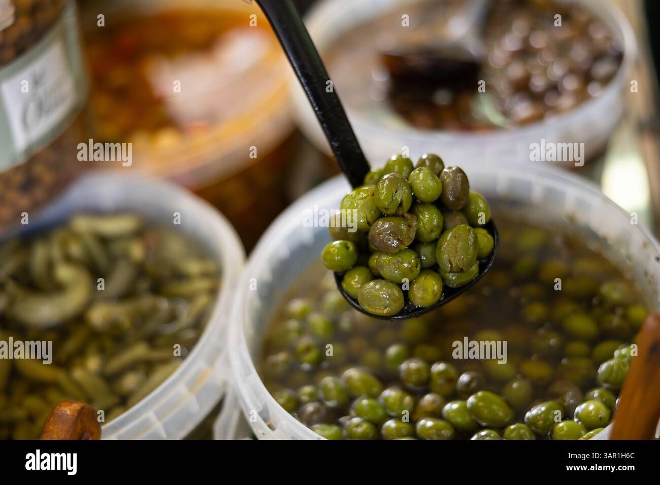 Heap of green olives with pits in buckets Stock Photo - Alamy