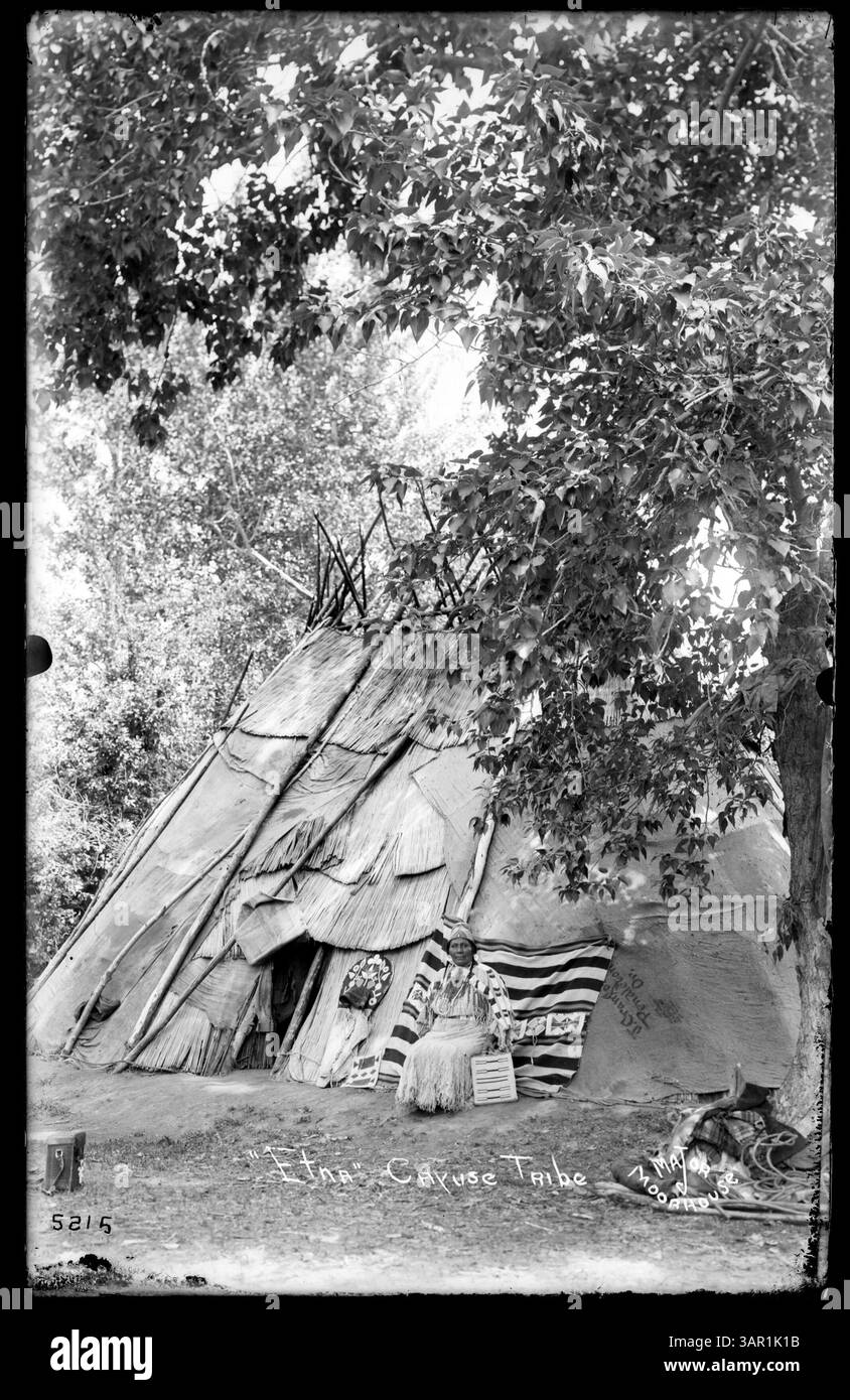 A photograph of Queen Etna, a Cayuse woman, in regalia outside a double ...