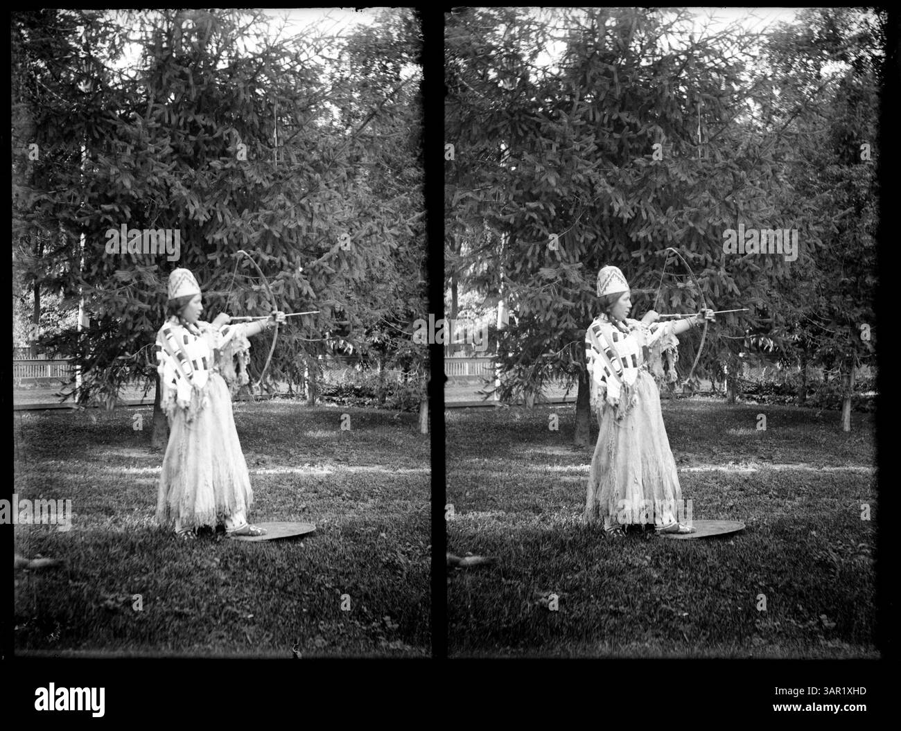 Photograph by Lee Moorhouse of a tribal woman in regalia, shooting a ...
