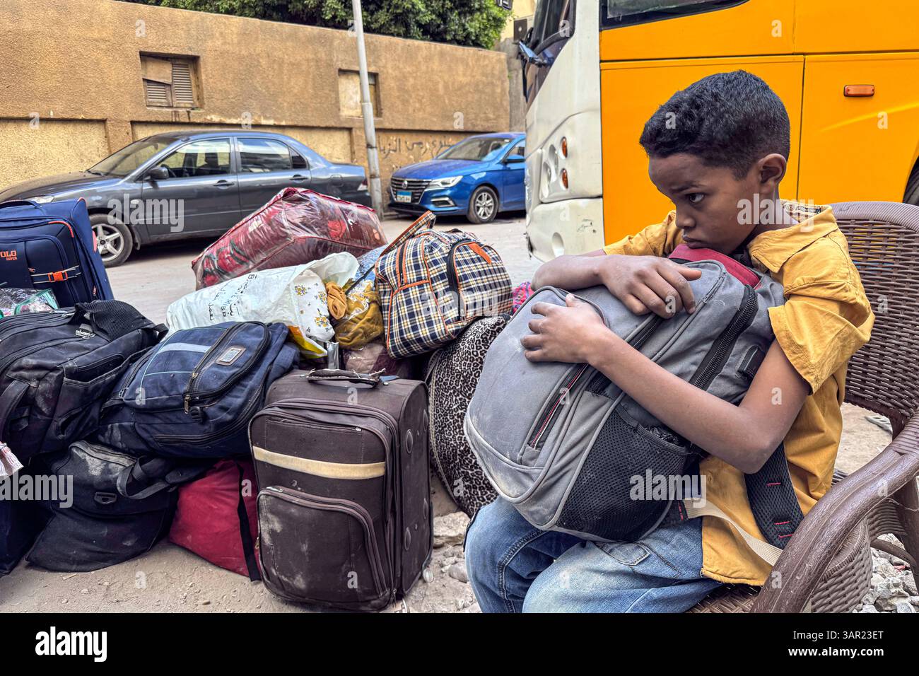 Cairo, Egypt. 13th Apr, 2025. A Sudanese boy waits to take a bus to ...