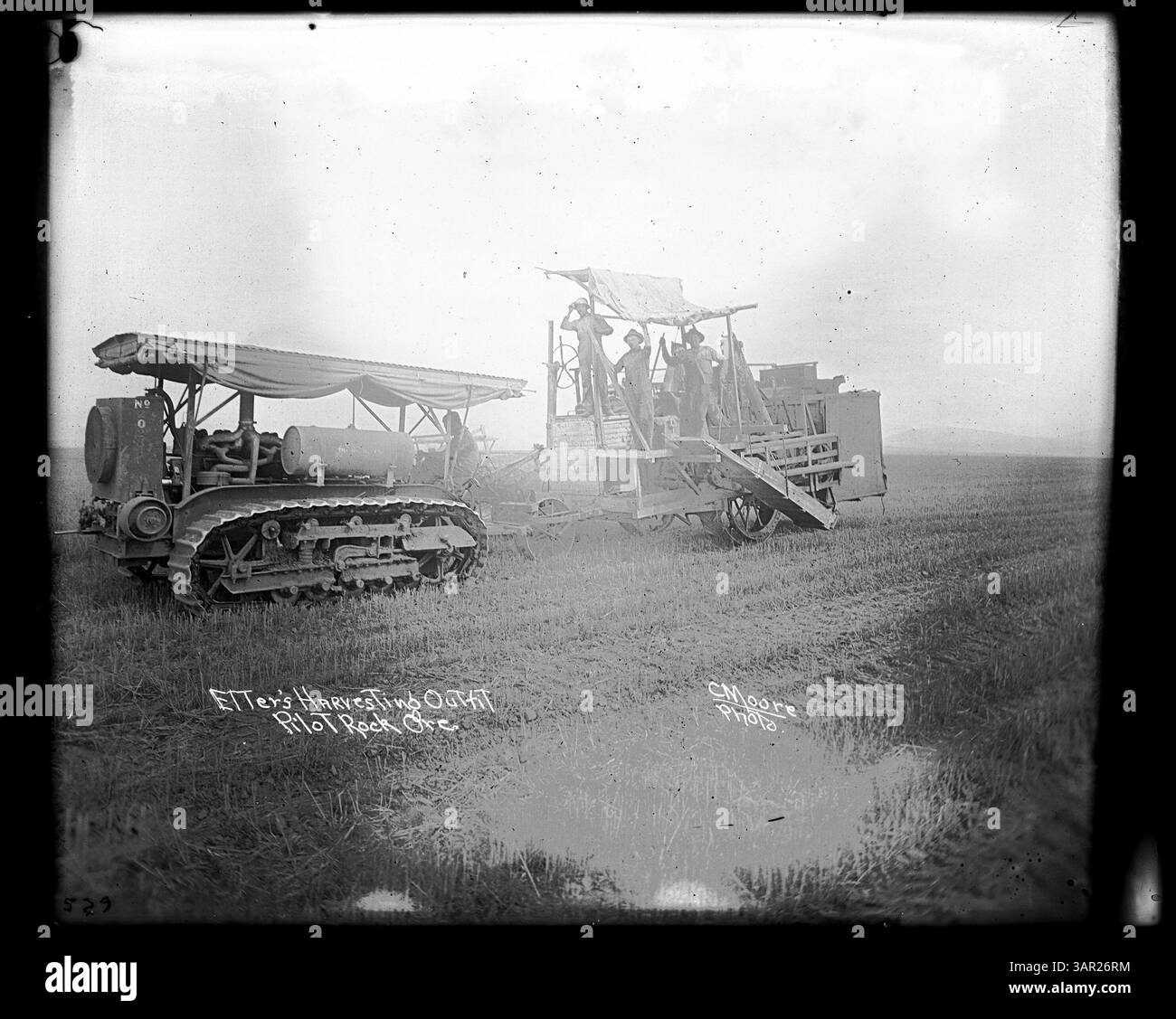 The image depicts Etter's harvesting outfit, a Holt tractor-drawn ...