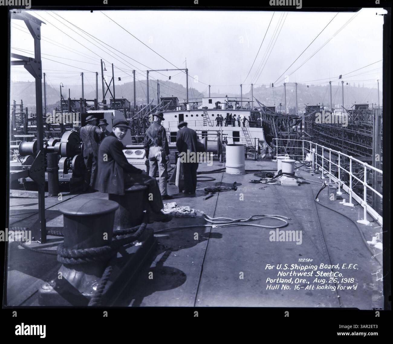 This image shows workers relaxing on the deck of Hull No. 16, a ship ...