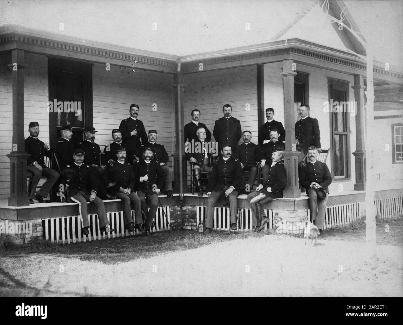 The photograph shows cavalry officers posing on the porch of a ...