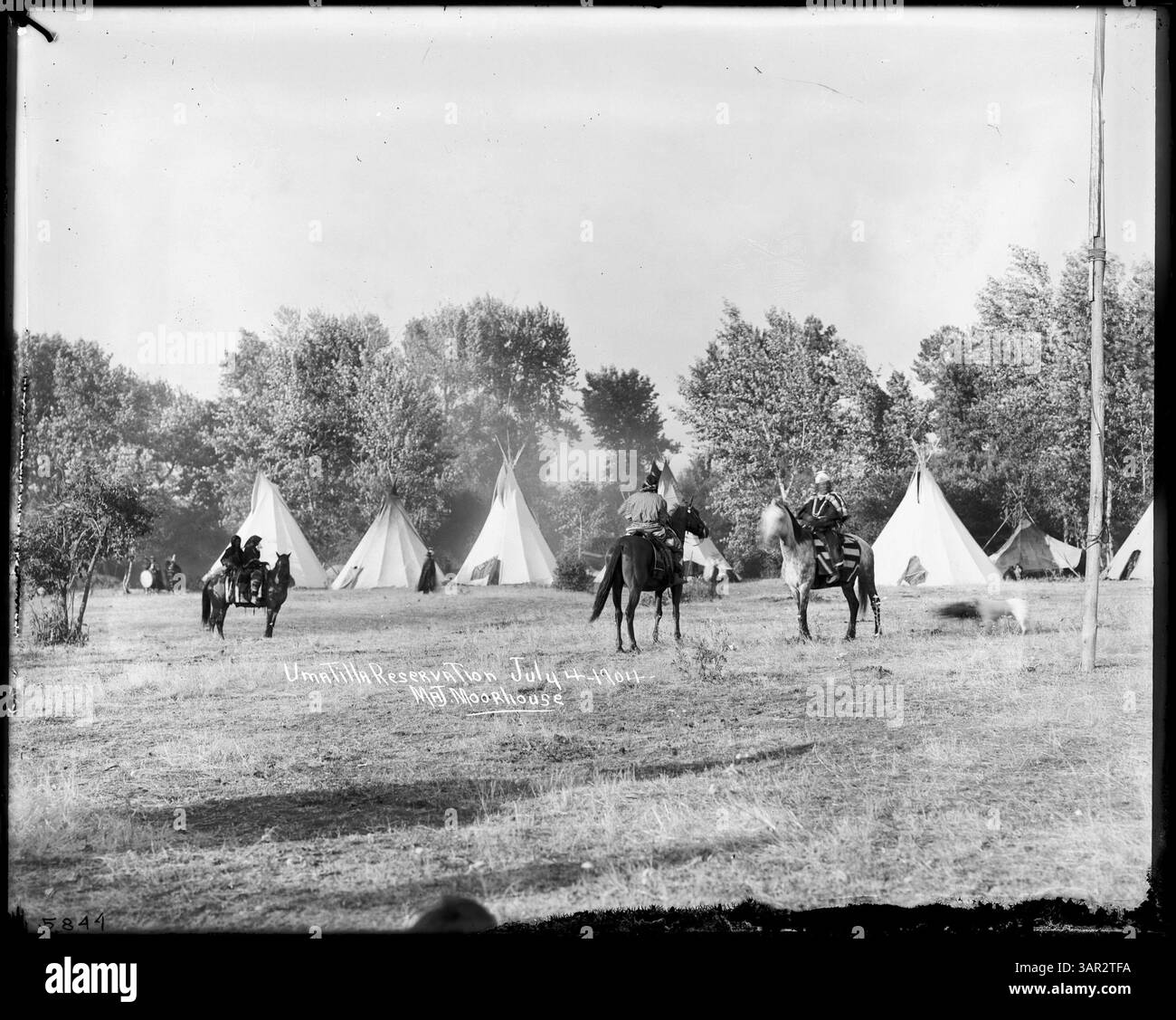 This black and white photograph by Lee Moorhouse shows several Native ...