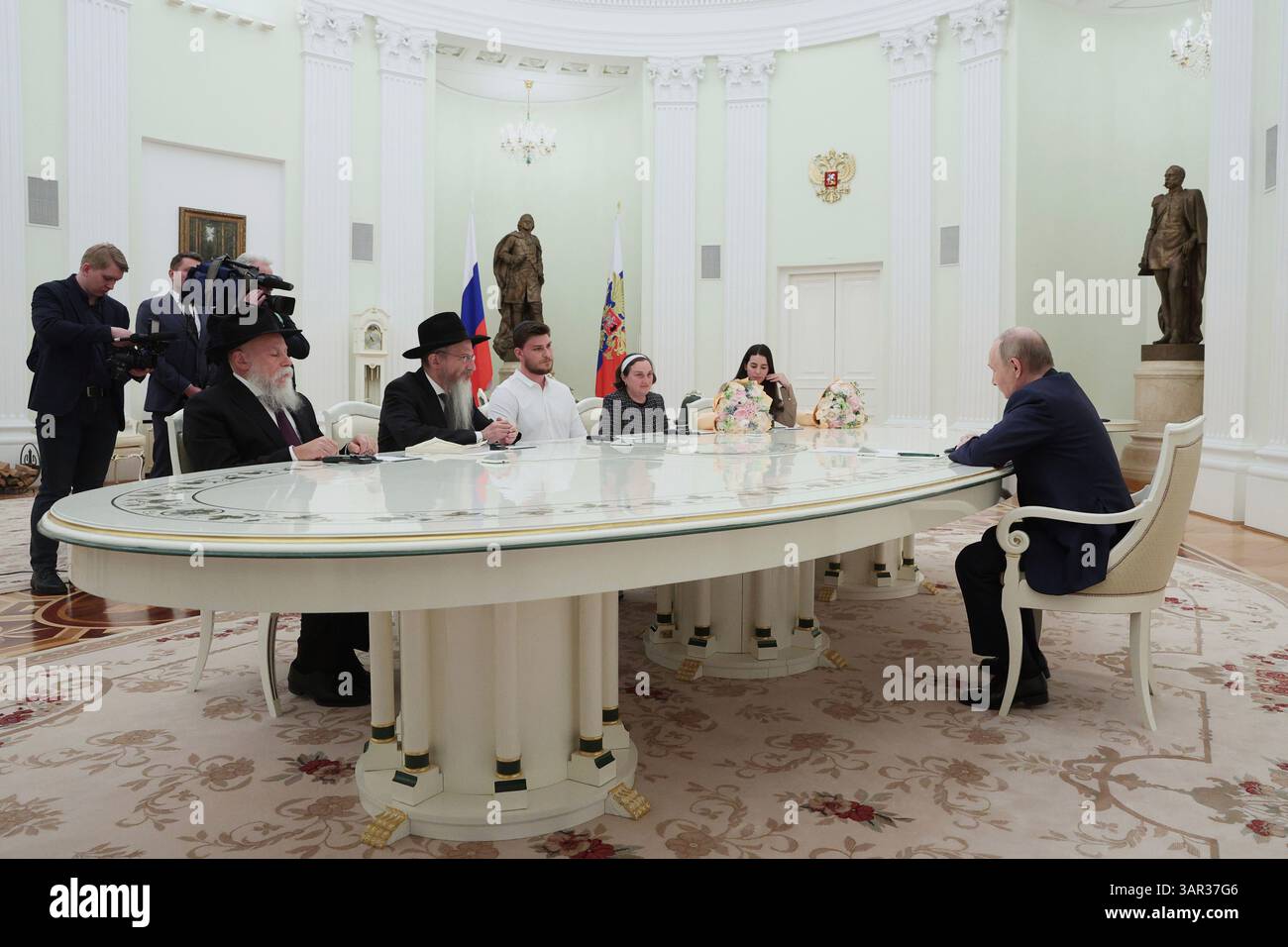 Russian President Vladimir Putin, right, accompanied by the President ...