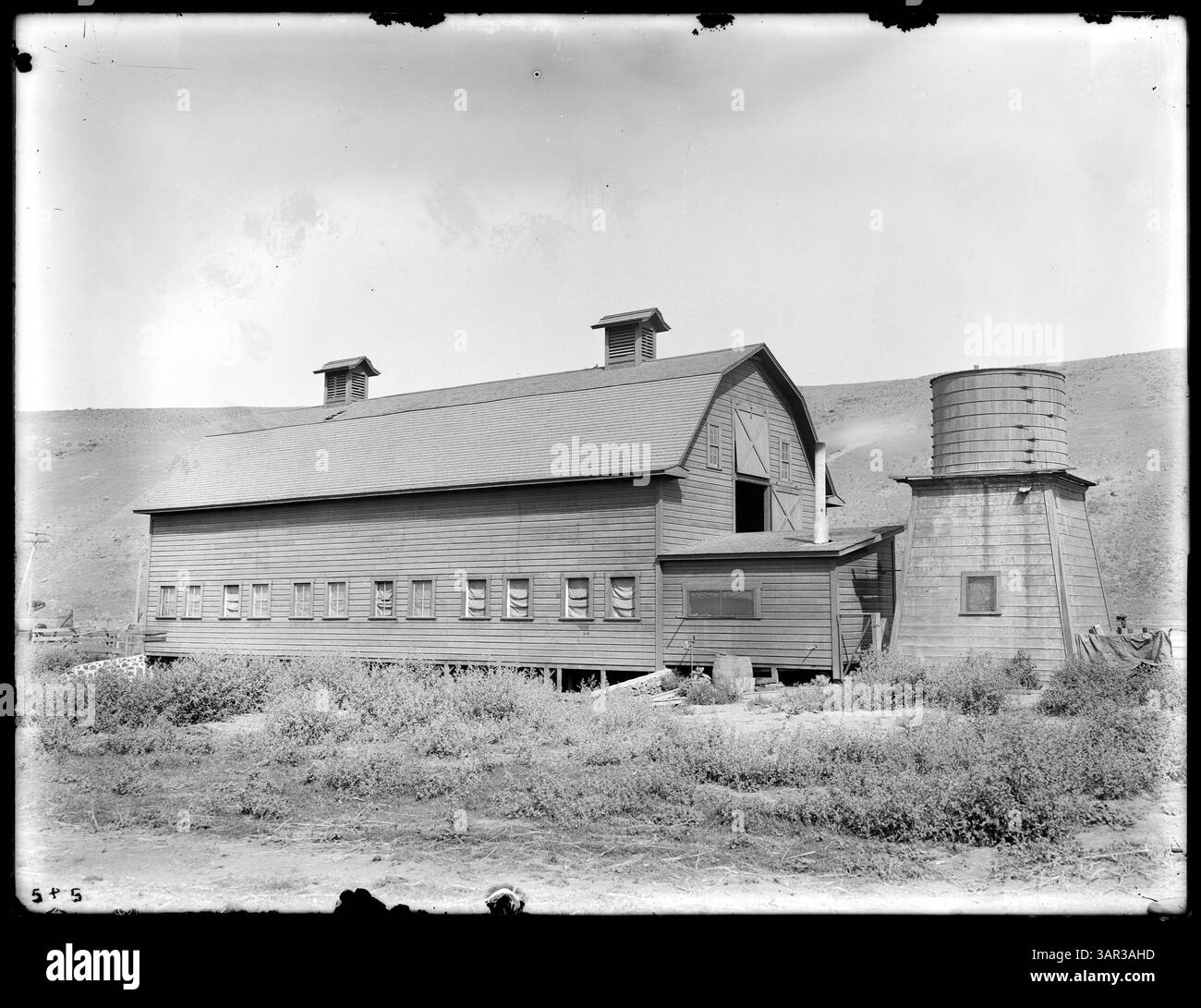 This photograph by Lee Moorhouse depicts the Hailey stock barn, pump ...