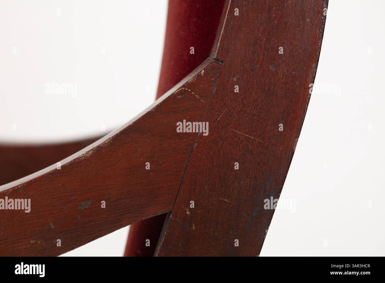 A high-backed priest's chair with red velvet upholstery and a wooden ...