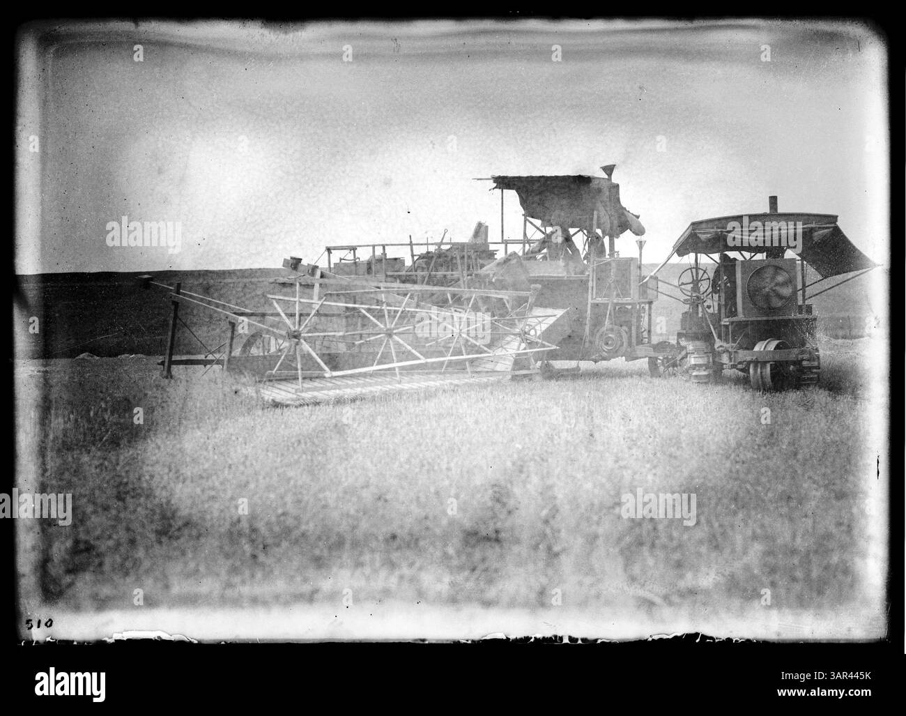 A photograph depicting a horse and oil tractor-drawn combines at the ...