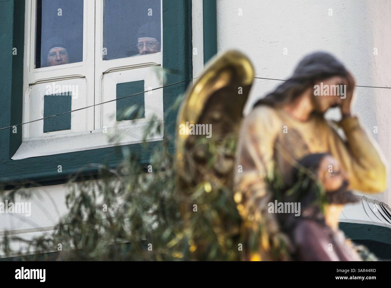 Nuns watch a Holy Week procession in Tunja, Colombia, Wednesday, April ...