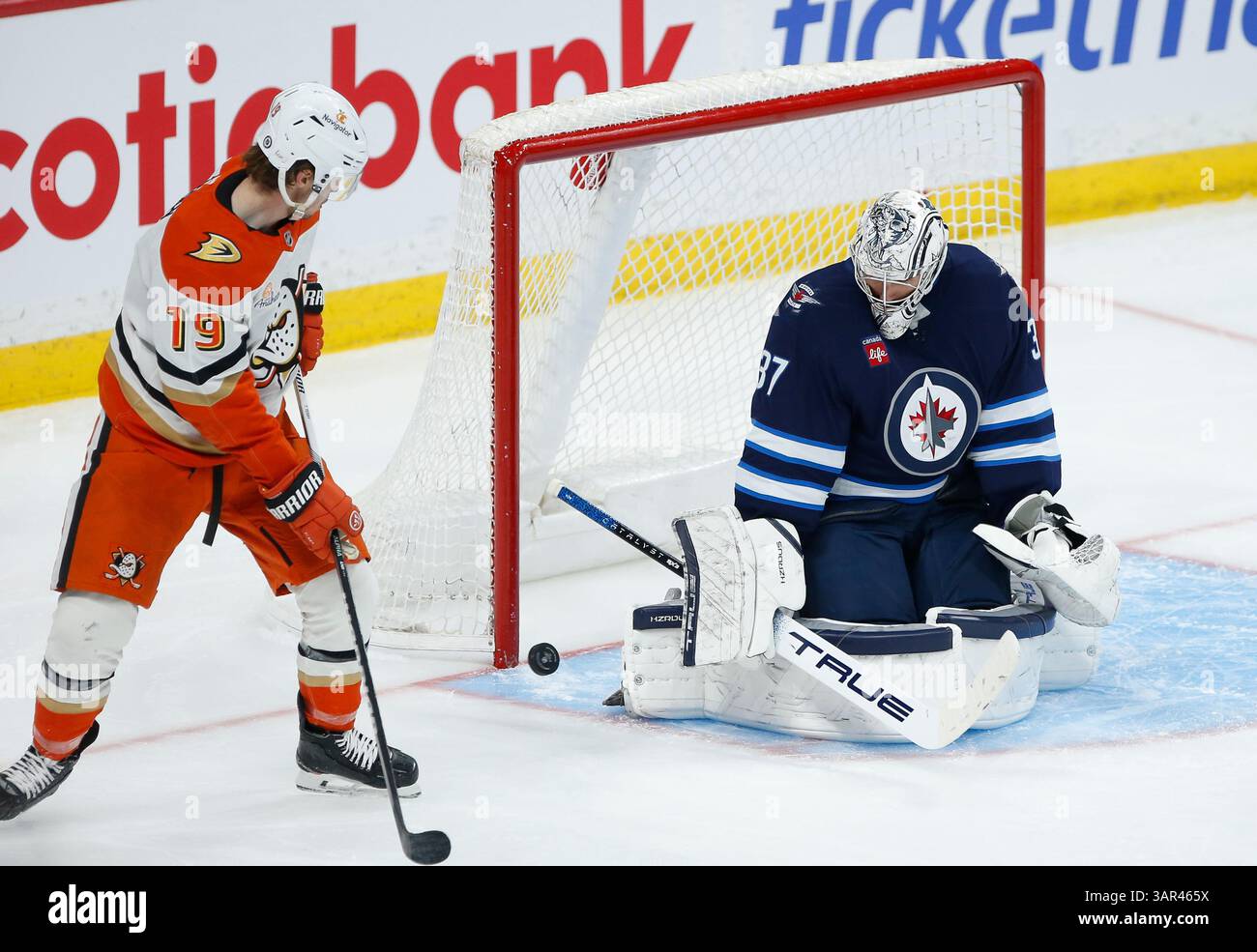 Winnipeg Jets goaltender Connor Hellebuyck (37) saves the shot from ...