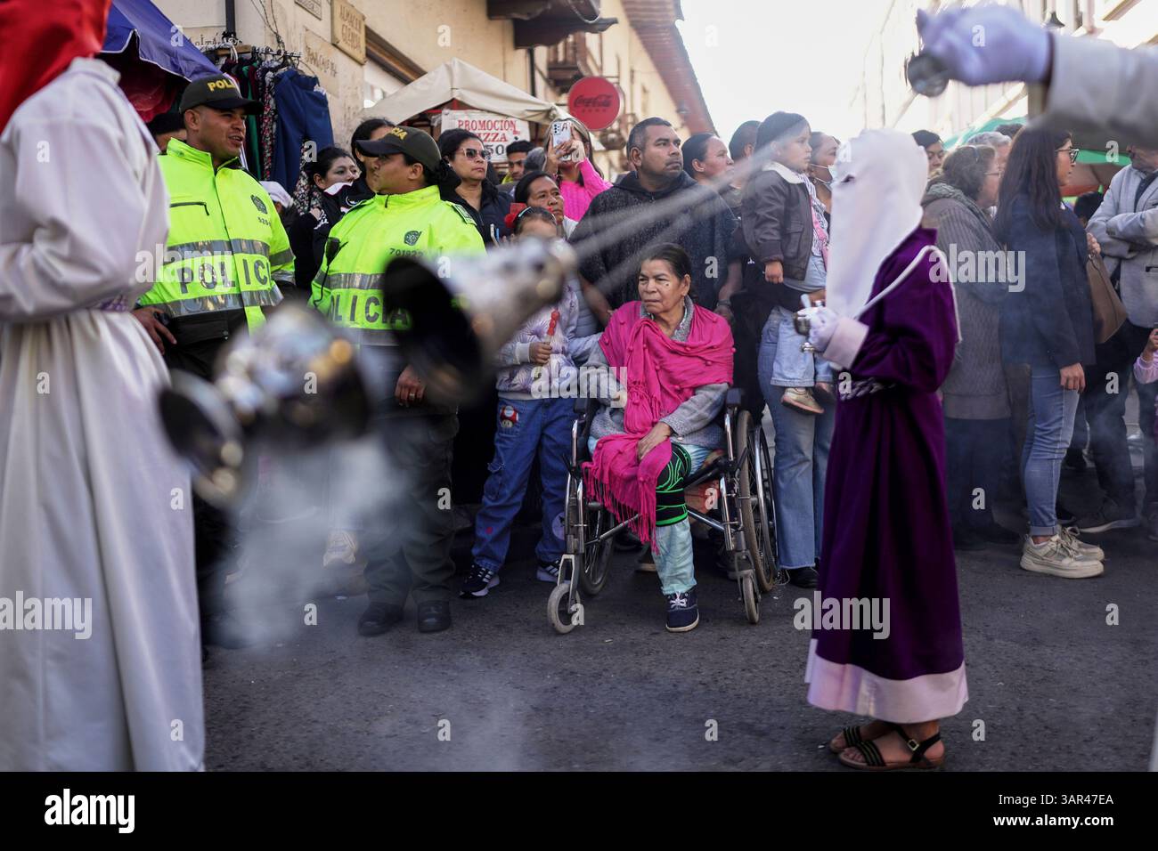Devotees attend a Holy Week procession in Tunja, Colombia, Wednesday ...