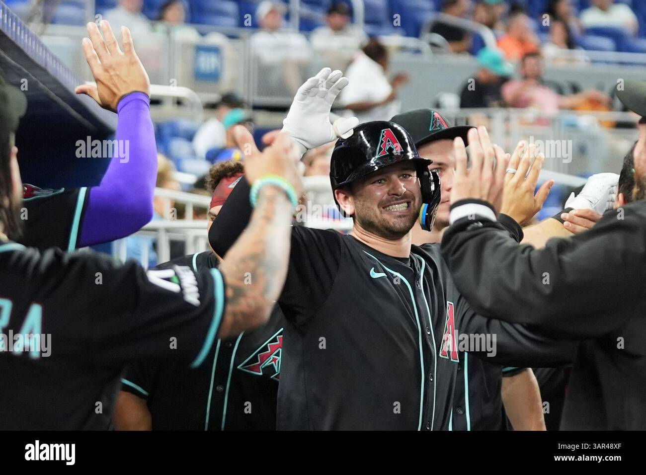 Arizona Diamondbacks' Tim Tawa is congratulated in the dugout after ...