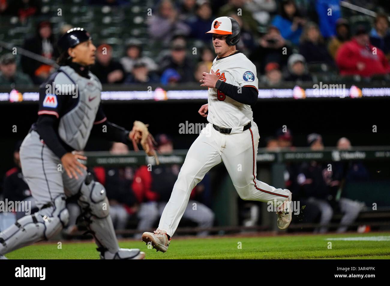 Baltimore Orioles' Ryan Mountcastle, right, scores past Cleveland ...