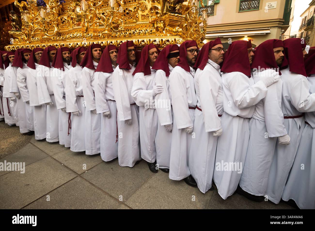 Penitents from ‘Estrella' brotherhood are seen carrying a statue of ...