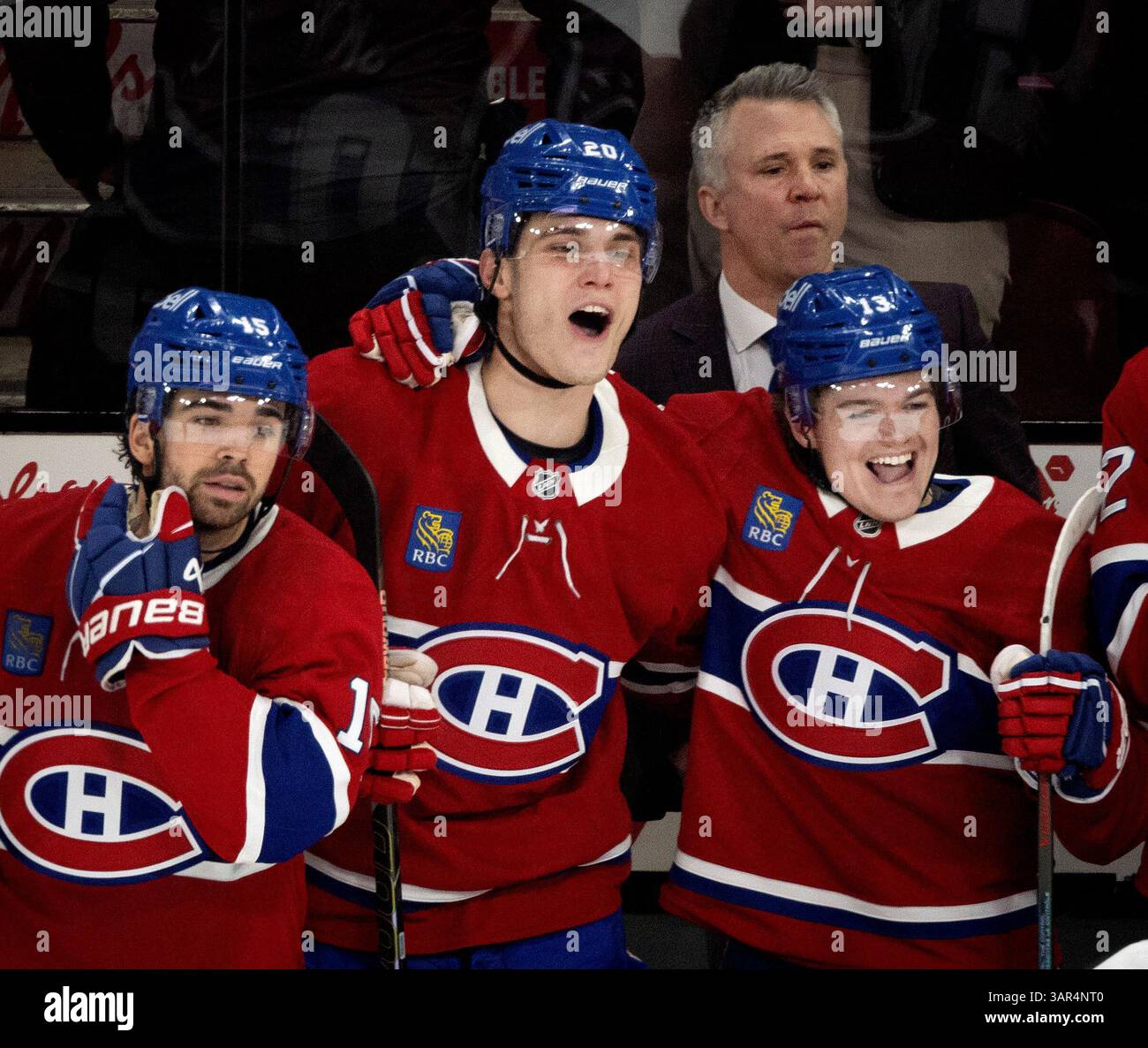 Montreal Canadiens' Alex Newhook (15), Juraj Slafkovsky (20) and Cole ...