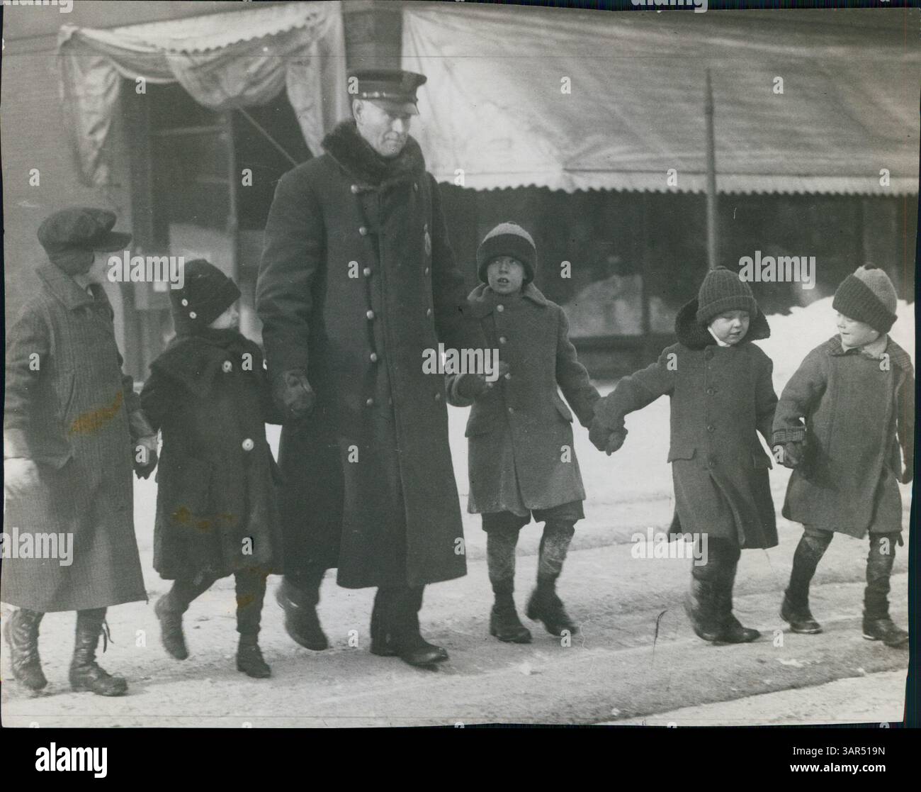 Patrolman Jim Flood is photographed escorting children across Nicollet ...