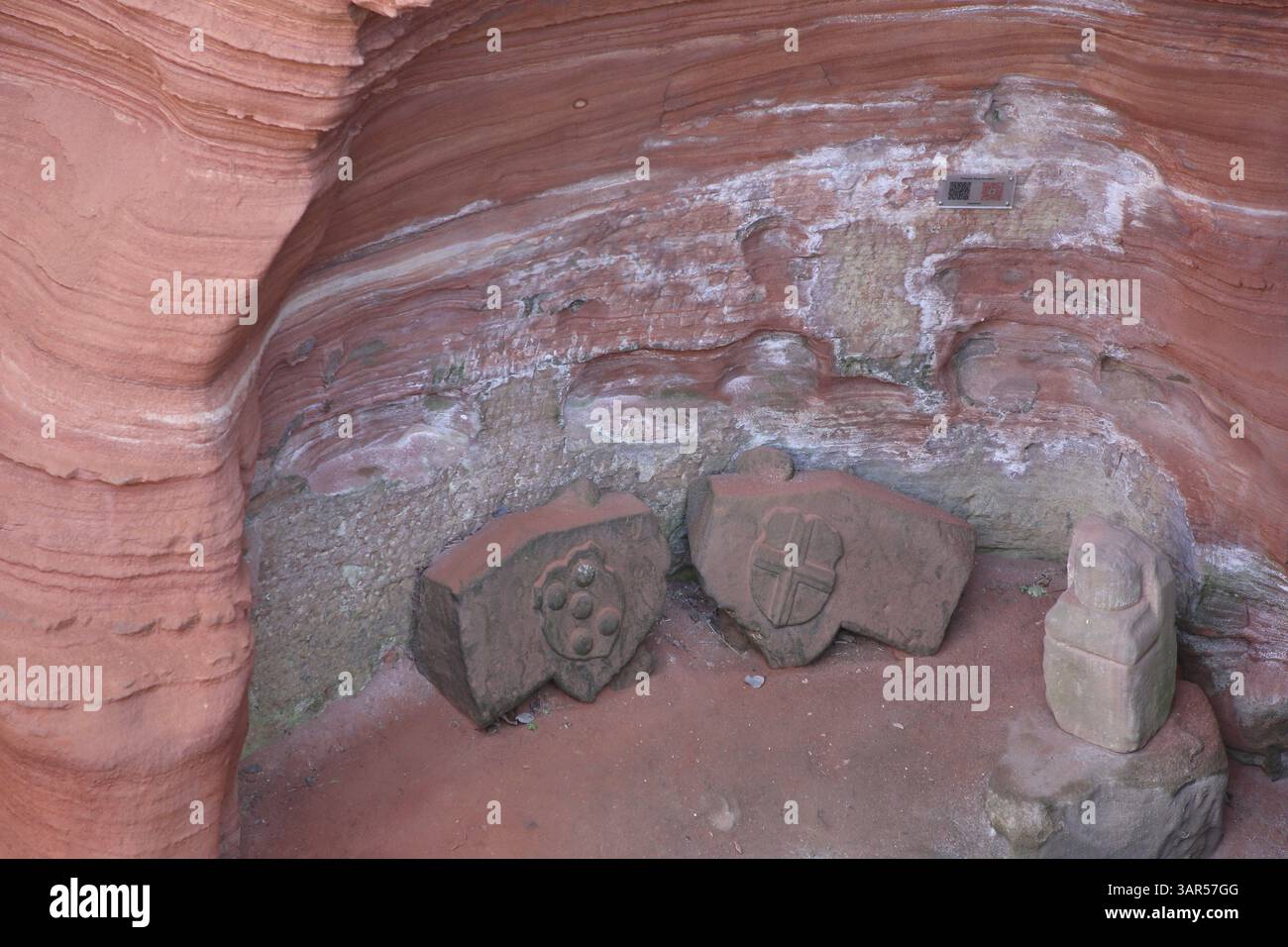 Two red stones with coat of arms, relief and rock layers on red ...