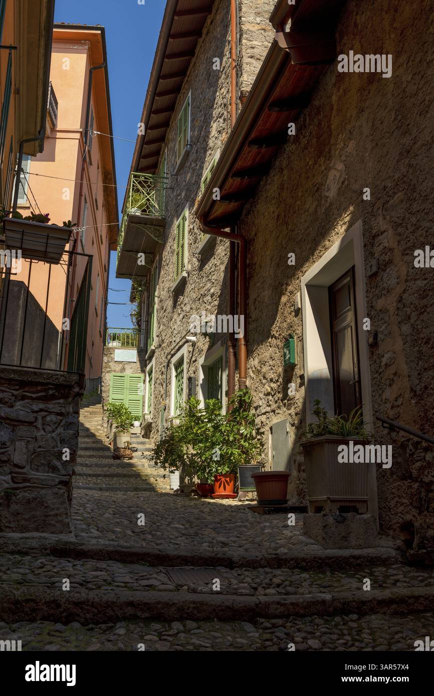Narrow alley with stairs in the historic fishing village of Varenna ...