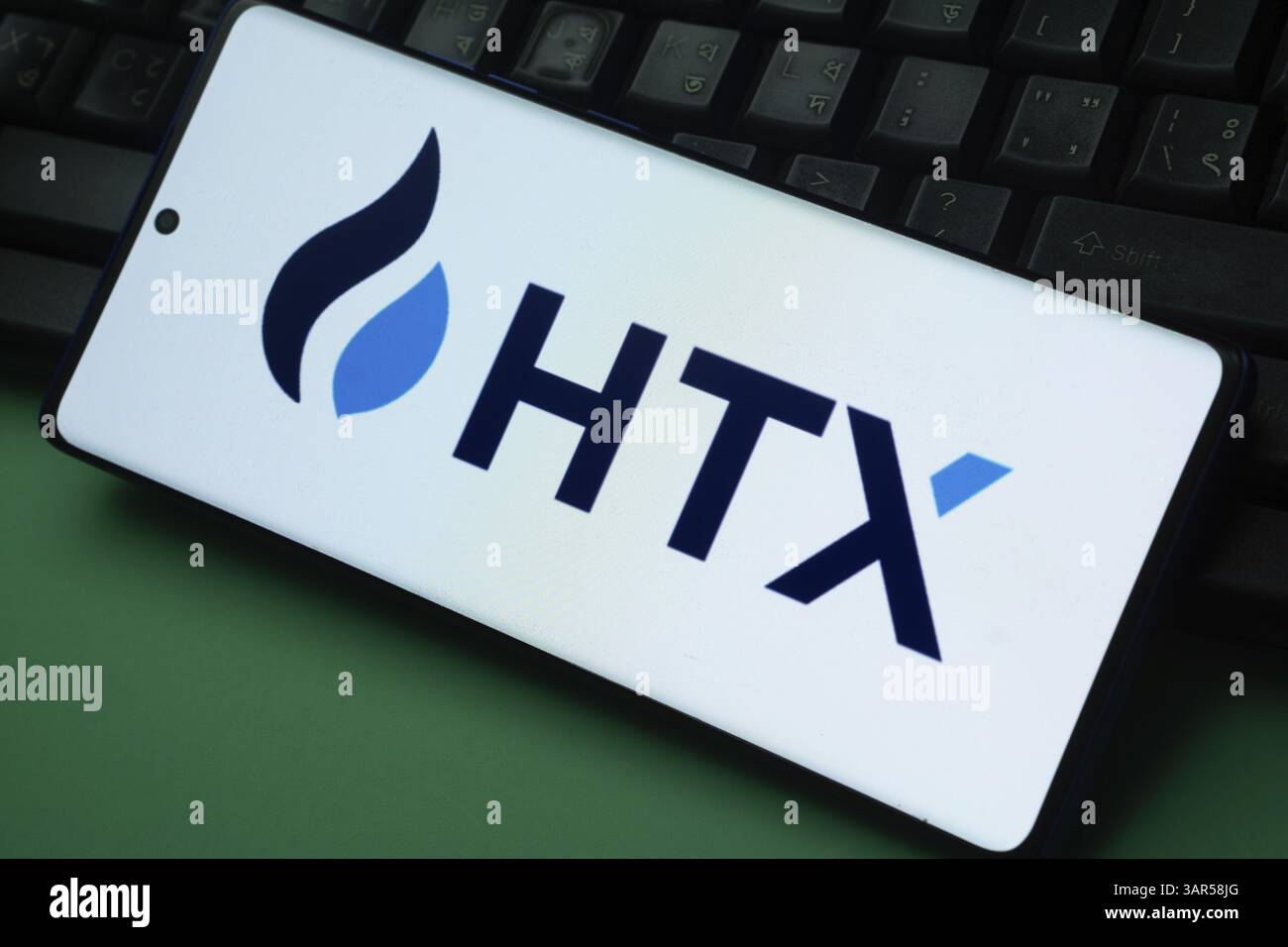 Dhaka, Bangladesh 11 March 2025: HTX, Huobi mobile logo app on a screen smartphone closeup. HTX ...