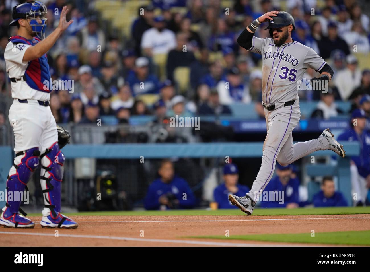 Colorado Rockies' Nick Martini, right, scores on a double by Kyle ...