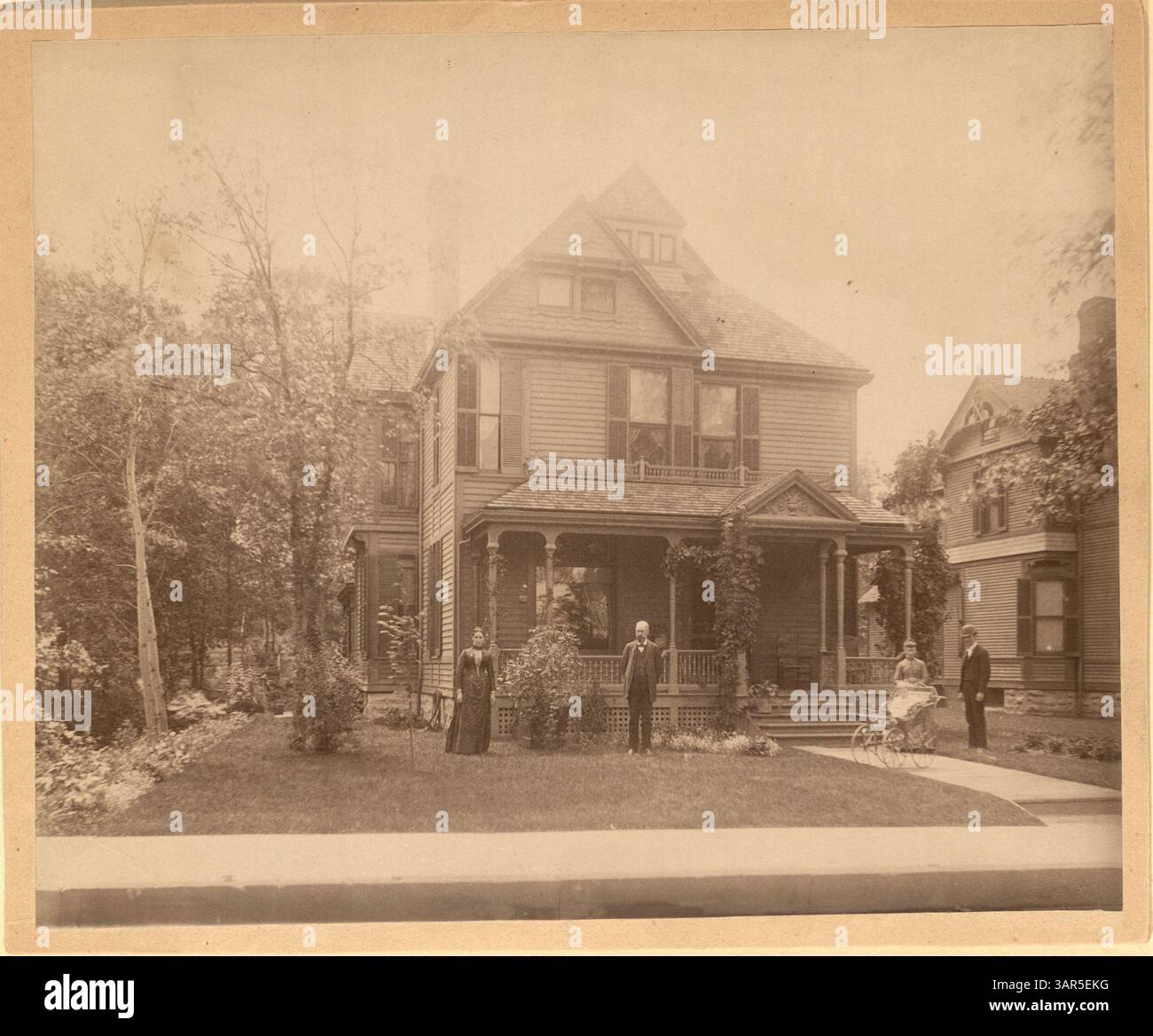 A posed photograph of the Allan Hill family in front of their home on ...