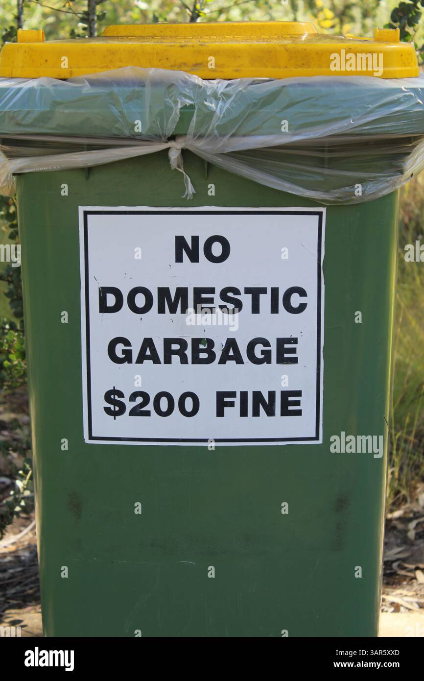"No Domestic Garbage $200 Fine" sign on the side of a green rubbish bin ...